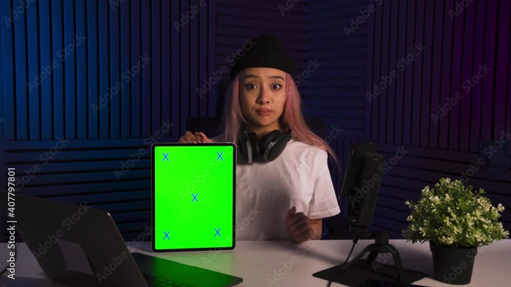 Zoomer asian girl emotionally recommended application on tablet or ...