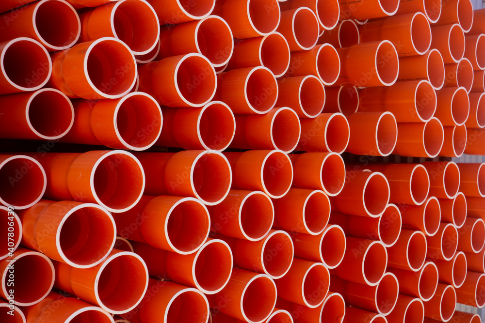 Stacked orange electrical conduit pipes making a pattern of circles ...