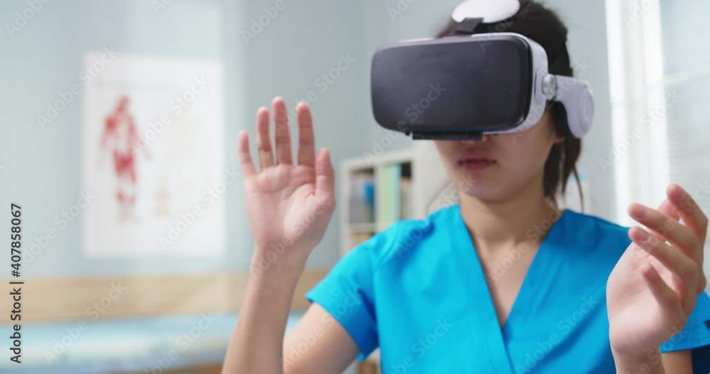 Smart female medical student using 3D glasses to do surgery in virtual ...