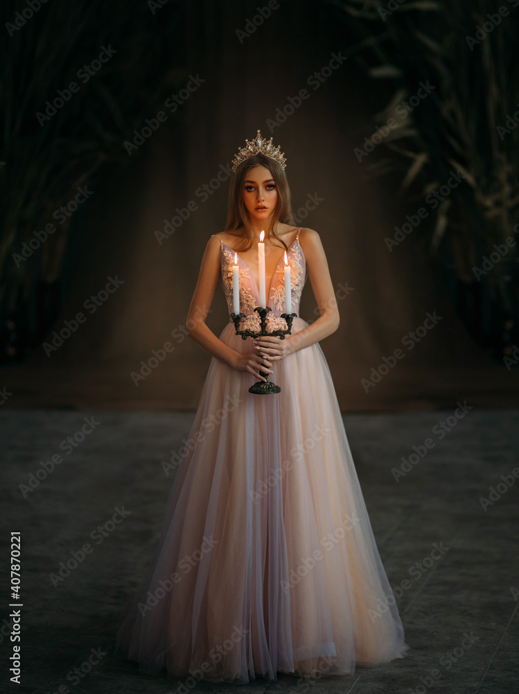 Art photo of medieval girl princess walks in dark gothic room. Woman ...