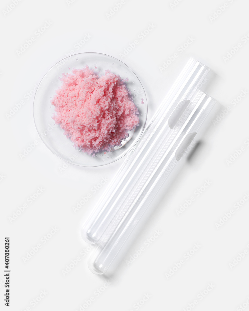 Pink flake chemicals in Chemical Watch Glass and test tube on white ...