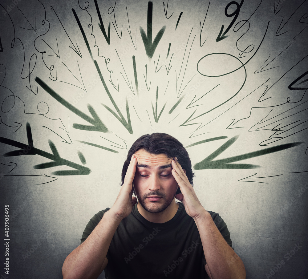Exhausted man keeps hands to temples, eyes closed, feels headache being ...