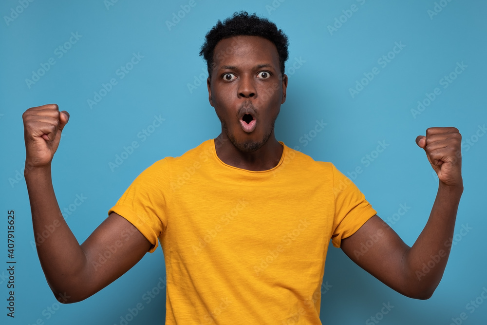 Happy excited african man screaming and celebrating succcess with two ...