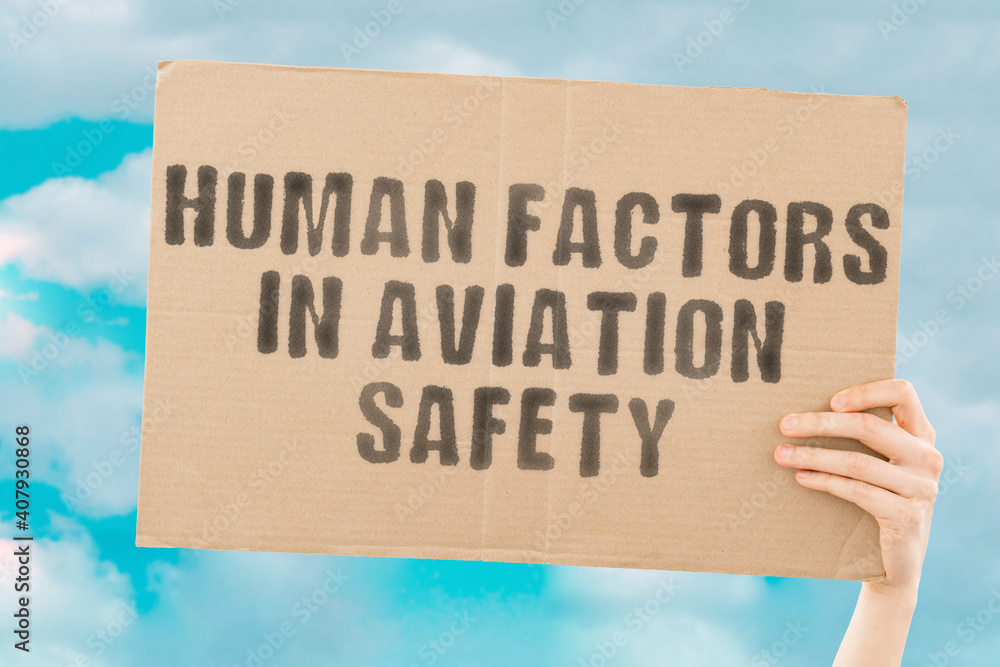 The phrase " Human factors in aviation safety " on a banner in men's ...