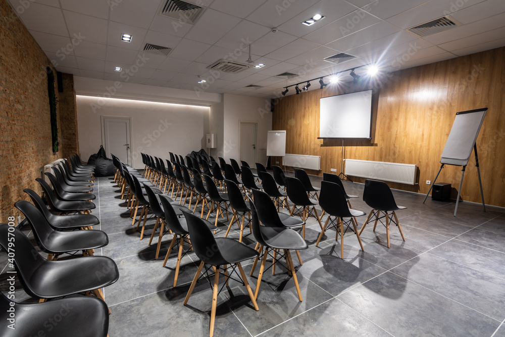 Interior of empty conference hall with black chairs, flipcharts and ...