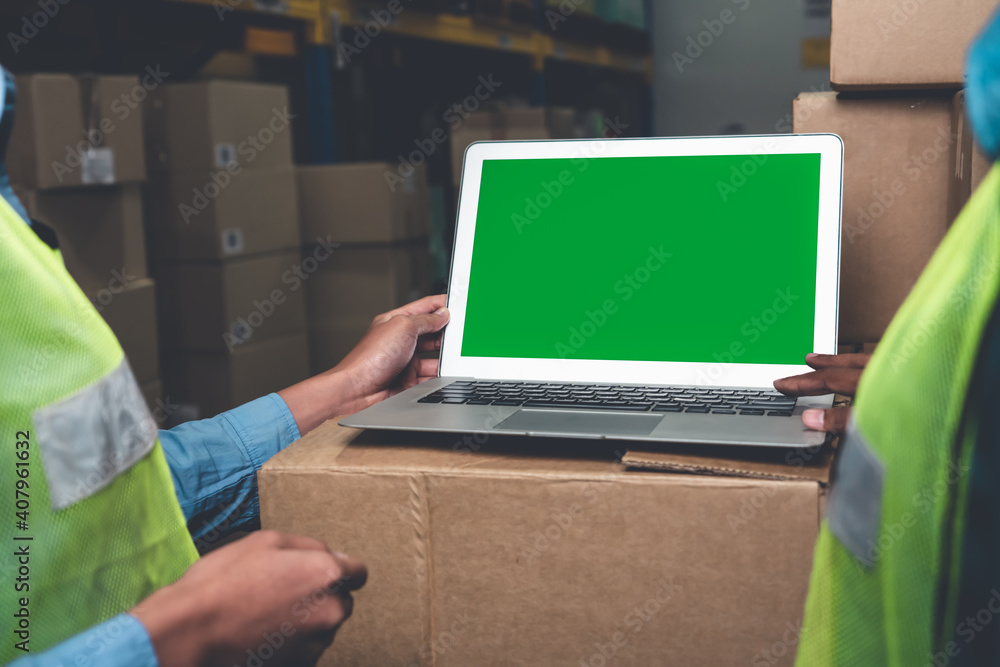 Computer with green screen display in warehouse storage room . Delivery ...