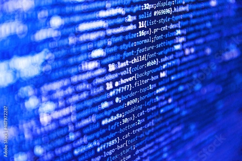 HTML CSS3 source code on lcd screen with black background. Developer working on program codes in ...