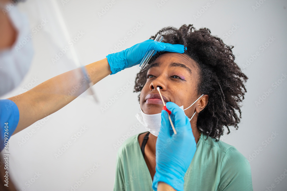Medic taking sample from patients nose for coronavirus testing. Young ...