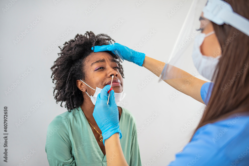 Close-up of a woman having PCR test at medical clinic. Close-up of ...
