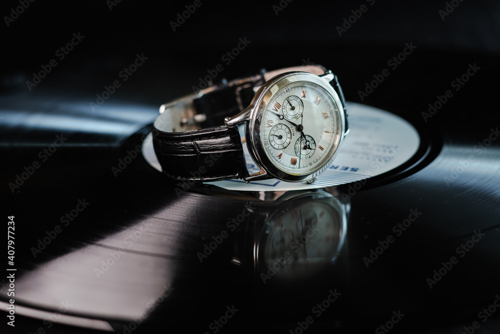Picture of an Elegant and classic watch on top of a vinyl disc. Stock ...