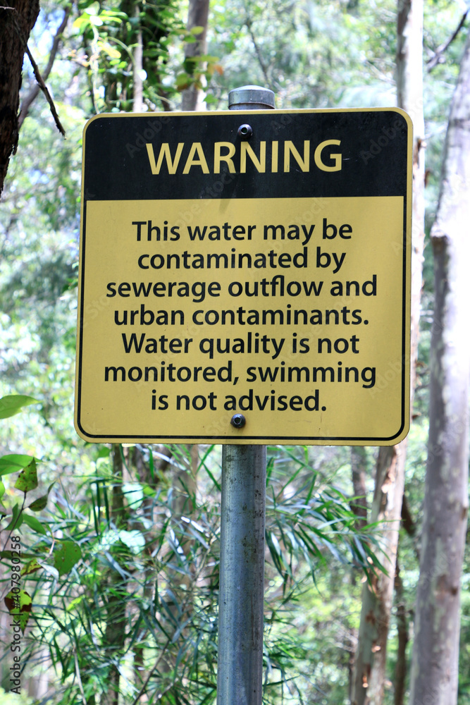 Warning sign in Australian bush: contaminated water, no swimming. Stock ...