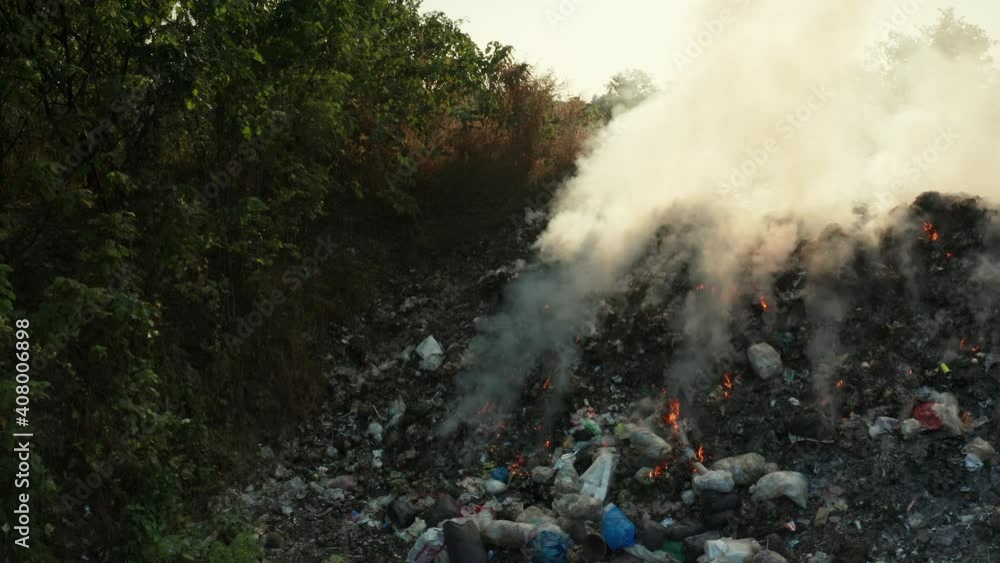 Garbage and fire burn in landfill. Also call trash, waste, rubbish ...