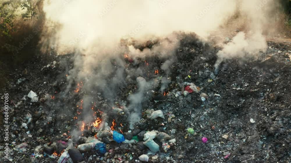 Garbage and fire burn in landfill. Also call trash, waste, rubbish ...