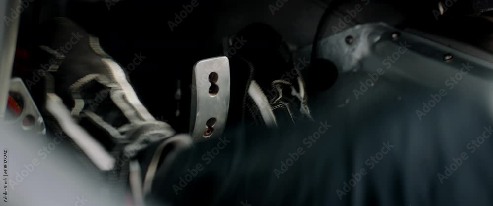 CU view of driver's legs pressing on pedals while racing inside a ...