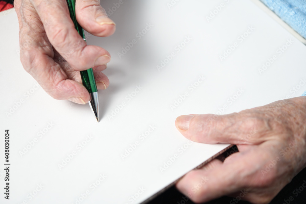 Hands of an old woman with a sheet for writing text.The hands of an old ...