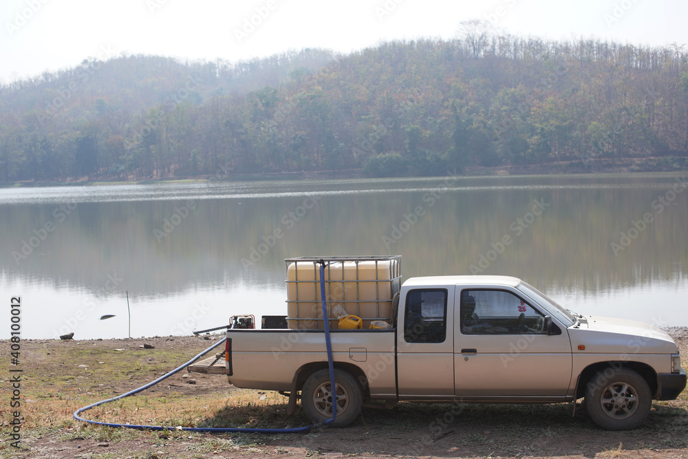 Water tank on a pickup truck in the lake,Tackling the drought of ...