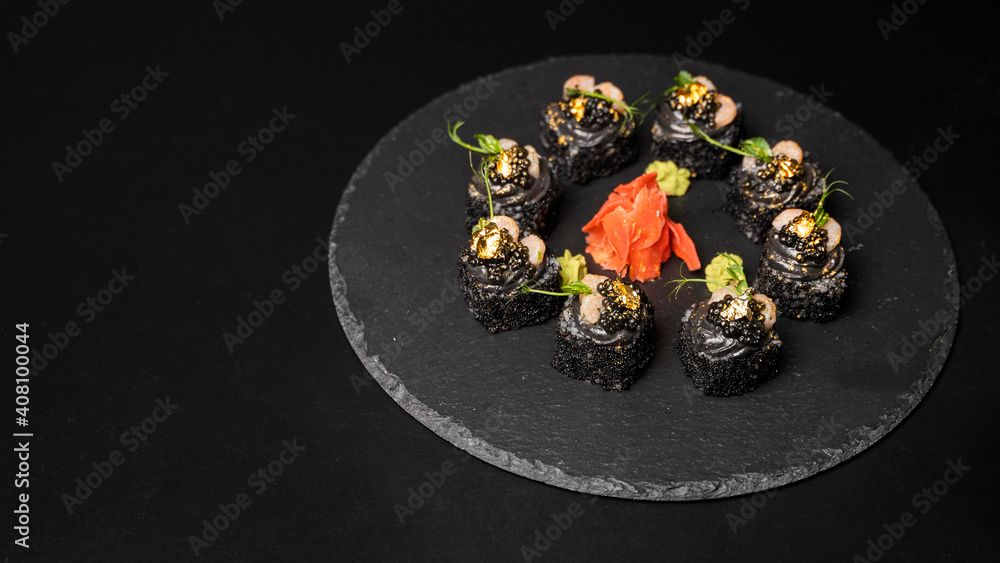 Sushi roll with nori, black rice, crab meat, cucumber, avocado, smoked ...