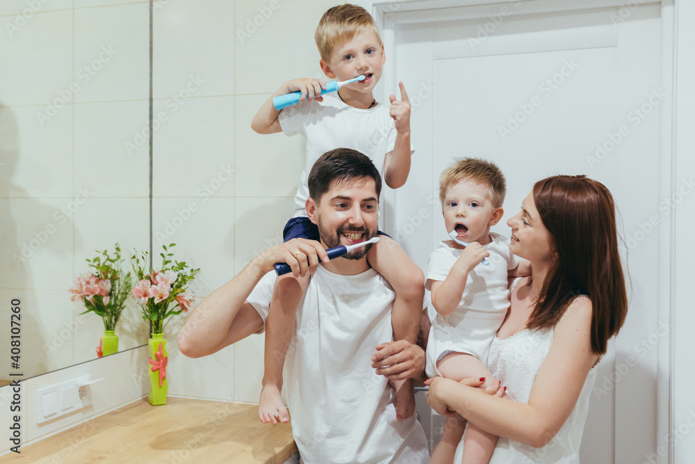 Young happy family man, woman and two small children, two boys in a ...