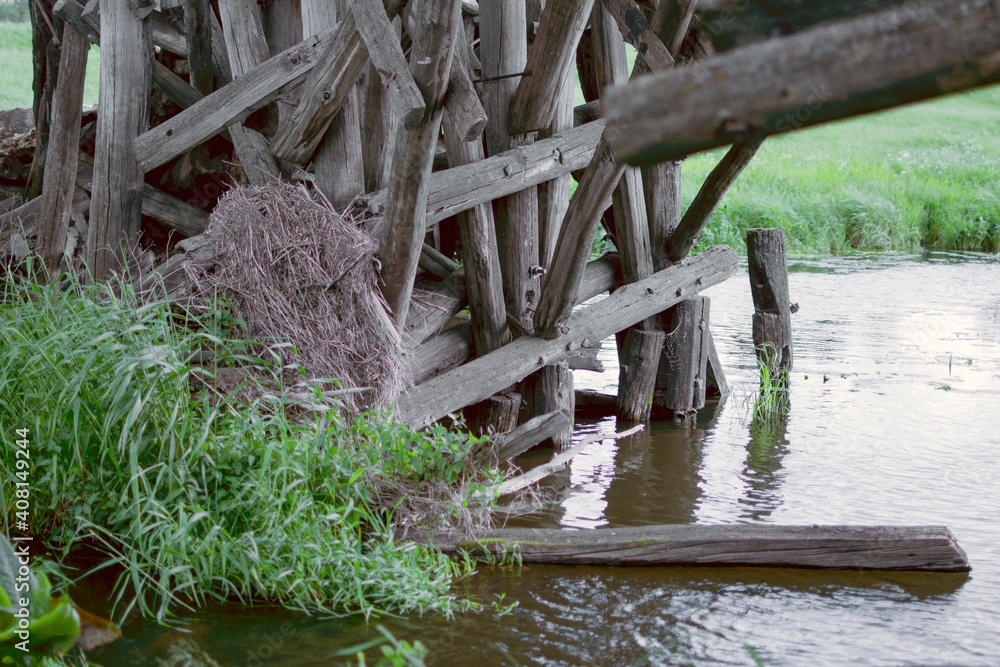 Logs of pillars of an old wooden bridge. Destroyed wooden old bridge ...