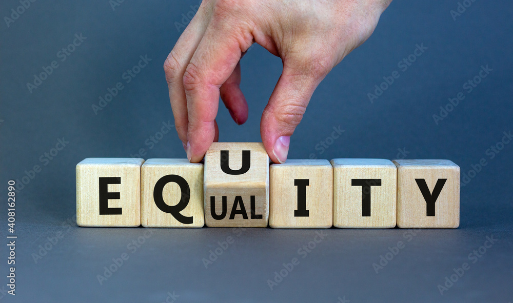 Equality or equity symbol. Businessman turns a cube and changs the word ...