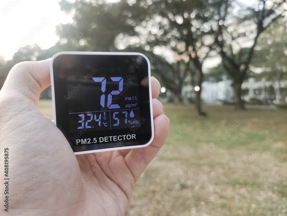 bad outdoor air quality. handheld pm2.5 dust sensor indicated harmful ...