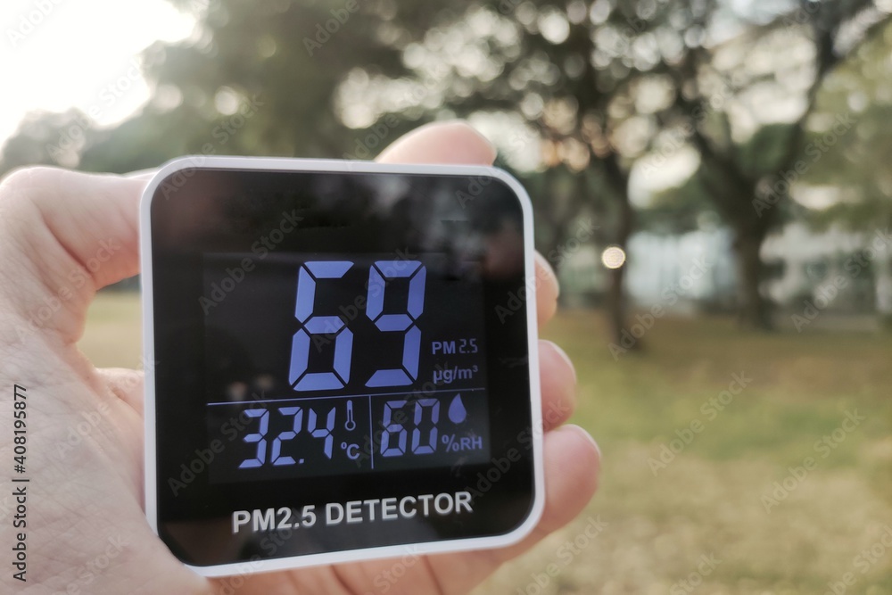 bad outdoor air quality. handheld pm2.5 dust sensor indicated harmful ...