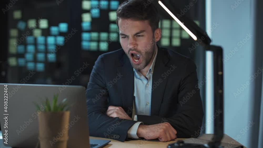 Overworked guy at work, office manager works late, a tired falls asleep ...