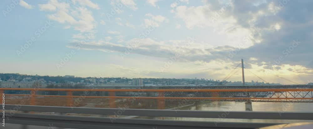 Side view through car window while driving on bridge above river. View ...