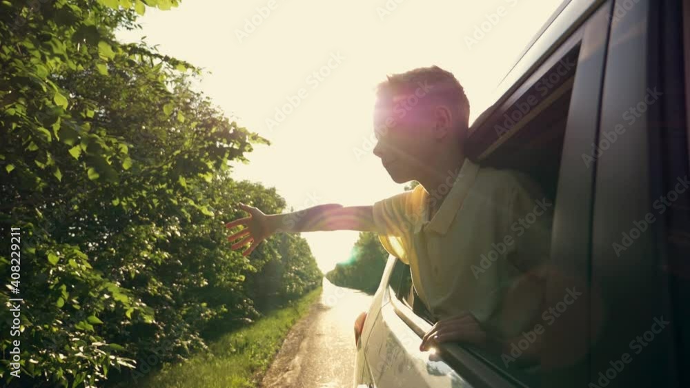 Happy child stretched out his hand from the car window. Happy family ...
