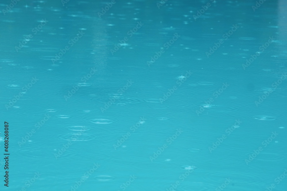 Swimming pool with water drops and reflection in the water in rainy day ...