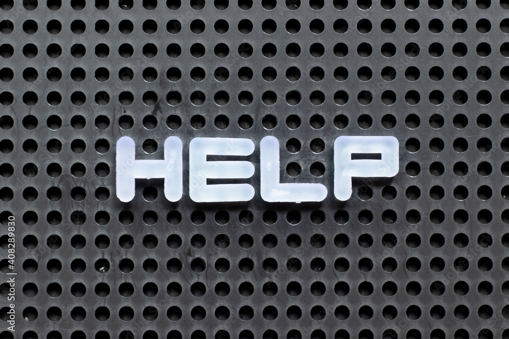 White color letter in word help on black pegboard background Stock ...