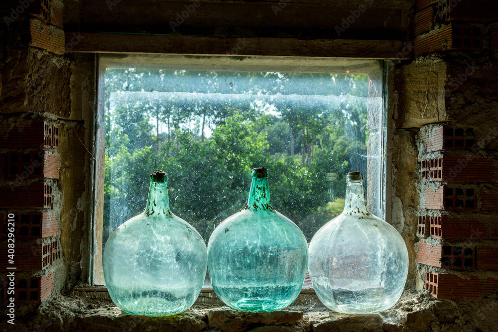 Old glass bottles damajuana Dame-Jeanne from a traditional village in ...