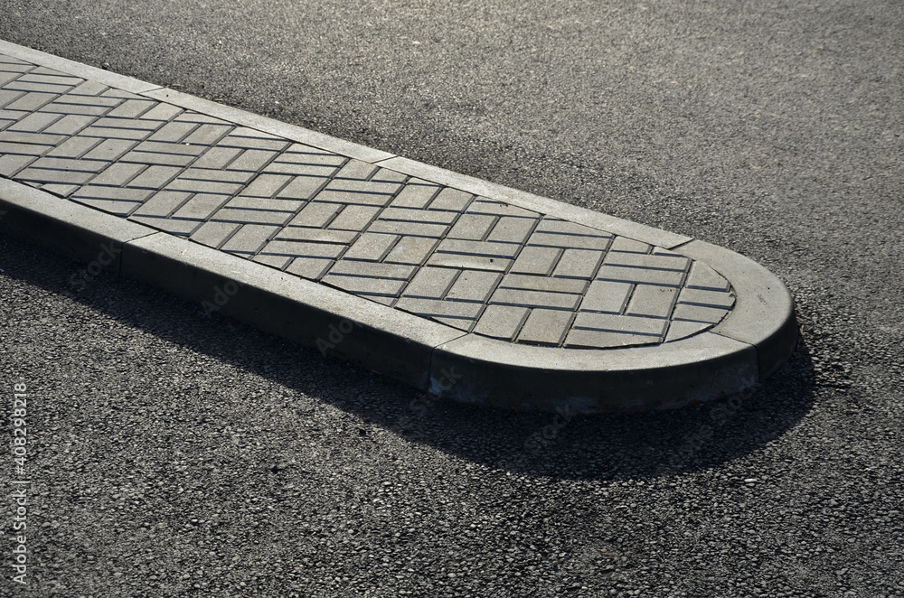 traffic island for the separation of lanes on an asphalt road. parking ...