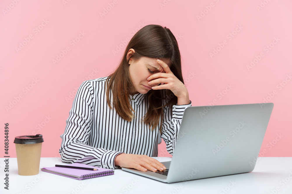 Depressed overworked woman office worker crying leaning head on hand ...