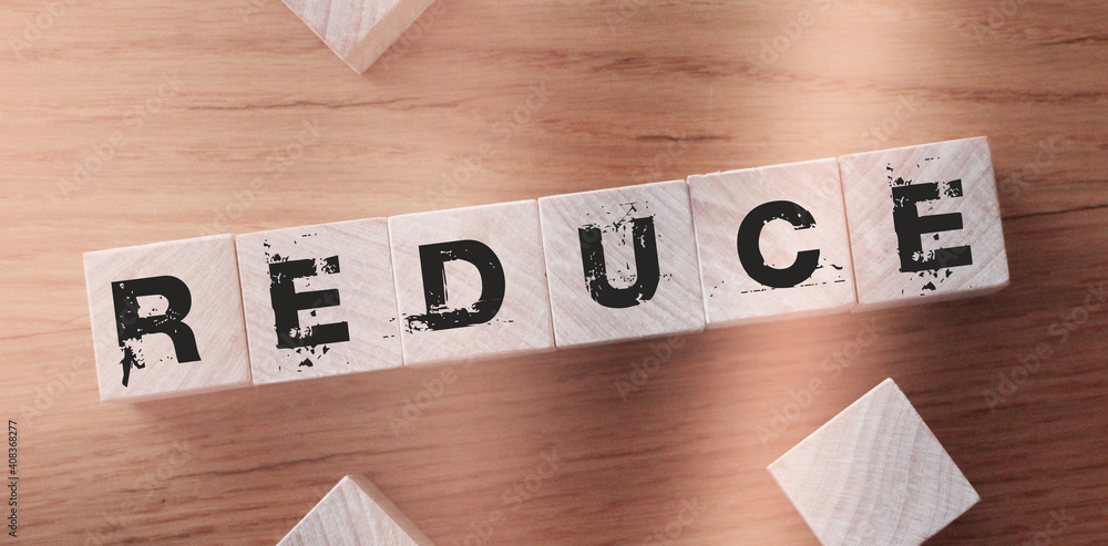 Reduce word written on wood block. Reduce, reuse and recycle ecological ...