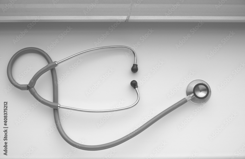 Stethoscope medical diagnostic device on a table near a window with ...