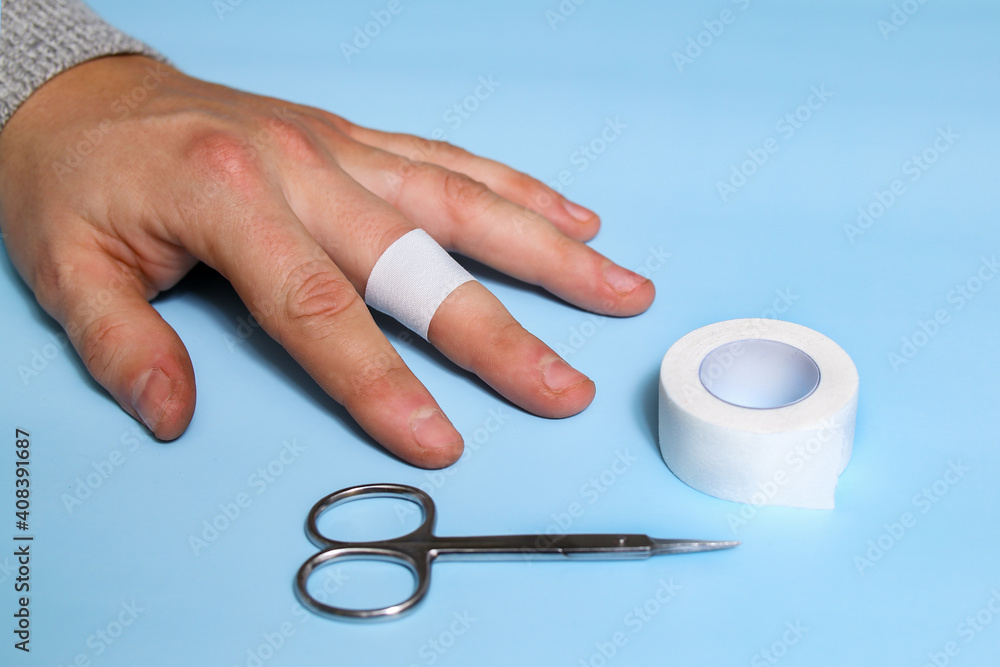 First aid for cuts and injuries to fingers. Man's hand with a wound ...