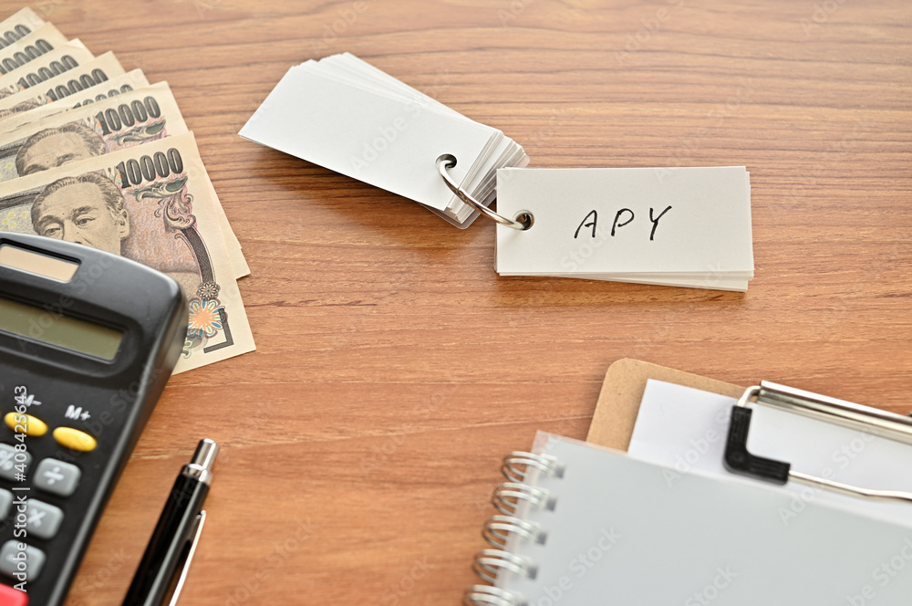 On the desk were Japanese yen bills, a calculator, a notebook, and a ...