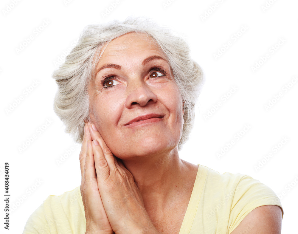 Elderly woman with her fingers to her chin reminiscing and recalling ... Elderly woman with her fingers to her chin reminiscing and recalling ...