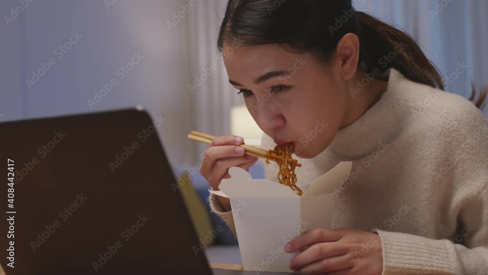 Young attractive beautiful asian female hungry eat instant noodles ...
