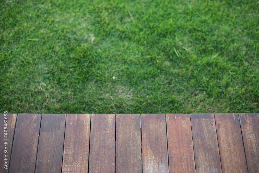 Empty wooden deck with green grass background. Stock Photo | Adobe Stock