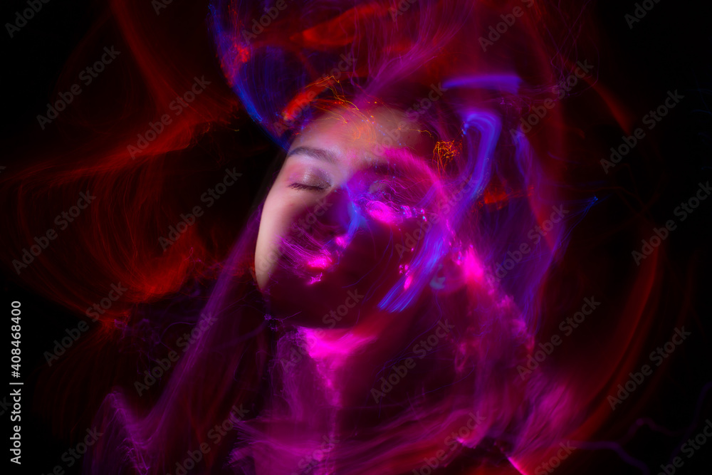 Portrait of young woman amid light painting , Over Black Background ...