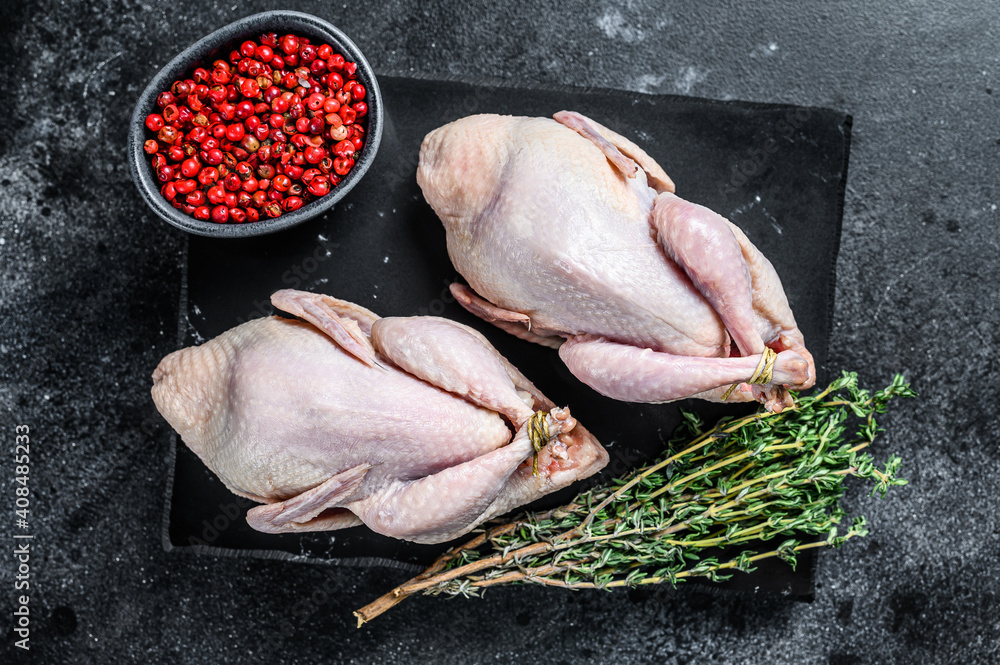 Farm eco friendly raw quails ready for cooking. Black background. Top ...