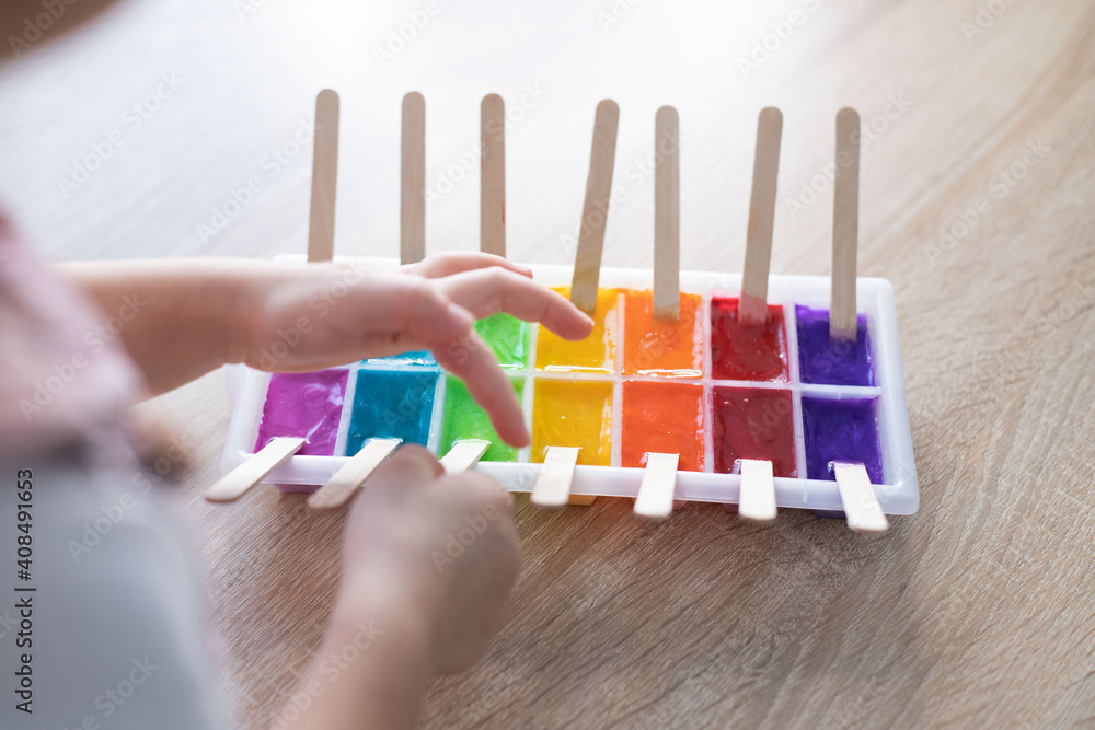 Child take an ice paints. Frozen paint easy process art activity. Stock ...