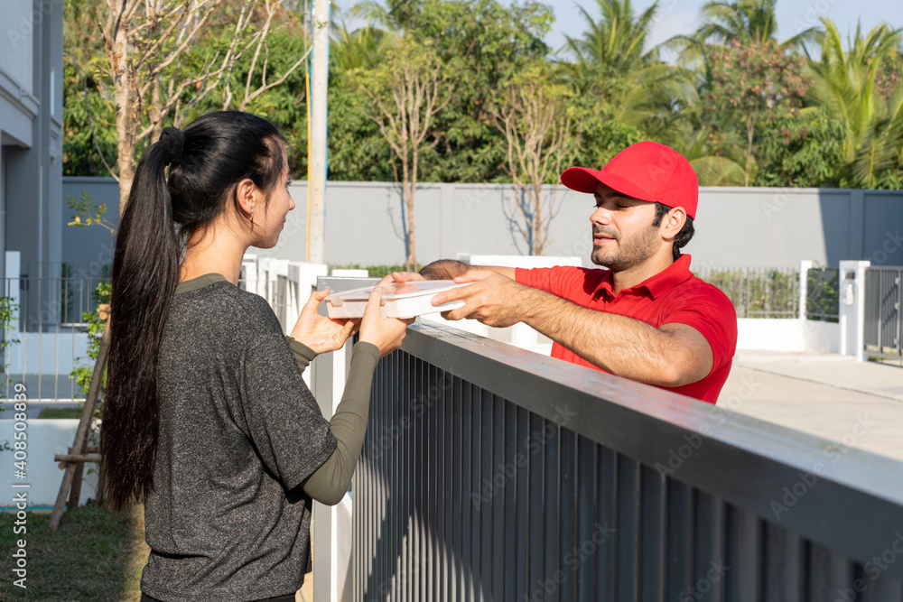Delivery staff, wearing red uniforms, delivering food boxes, young ...