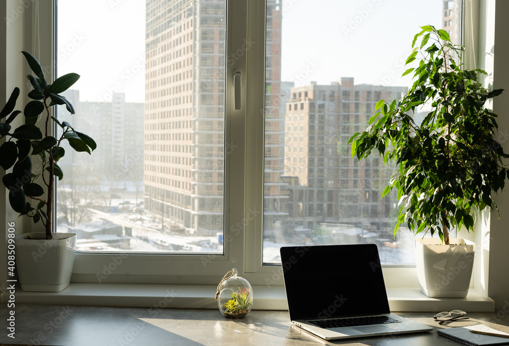 Still life view of office room with open laptop computer on desk with ...