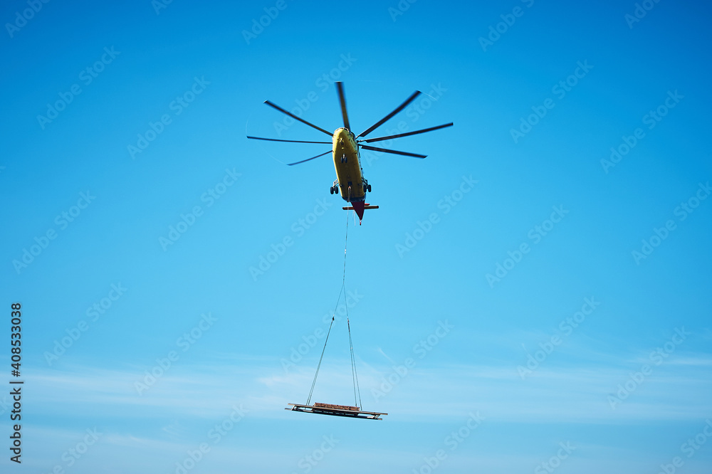 The world's largest cargo helicopter hovers overhead. Bottom view.The ...