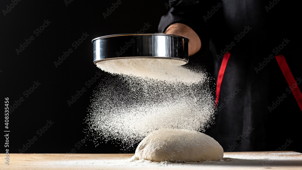 professional Chef hands prepares dough from flour to cook Italian pasta ...