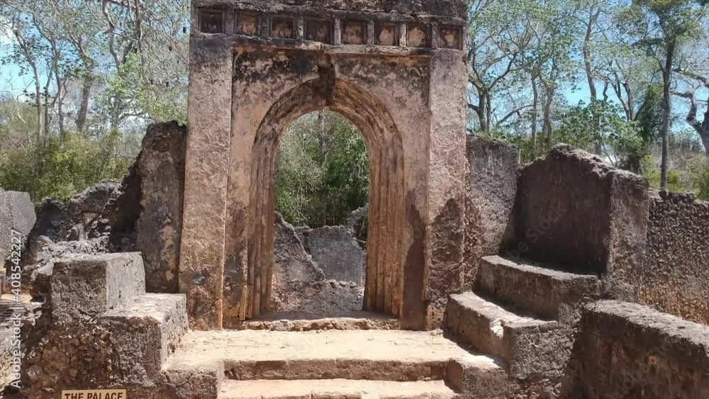 Ancient arch of African settlement, panning into the arch, light ...