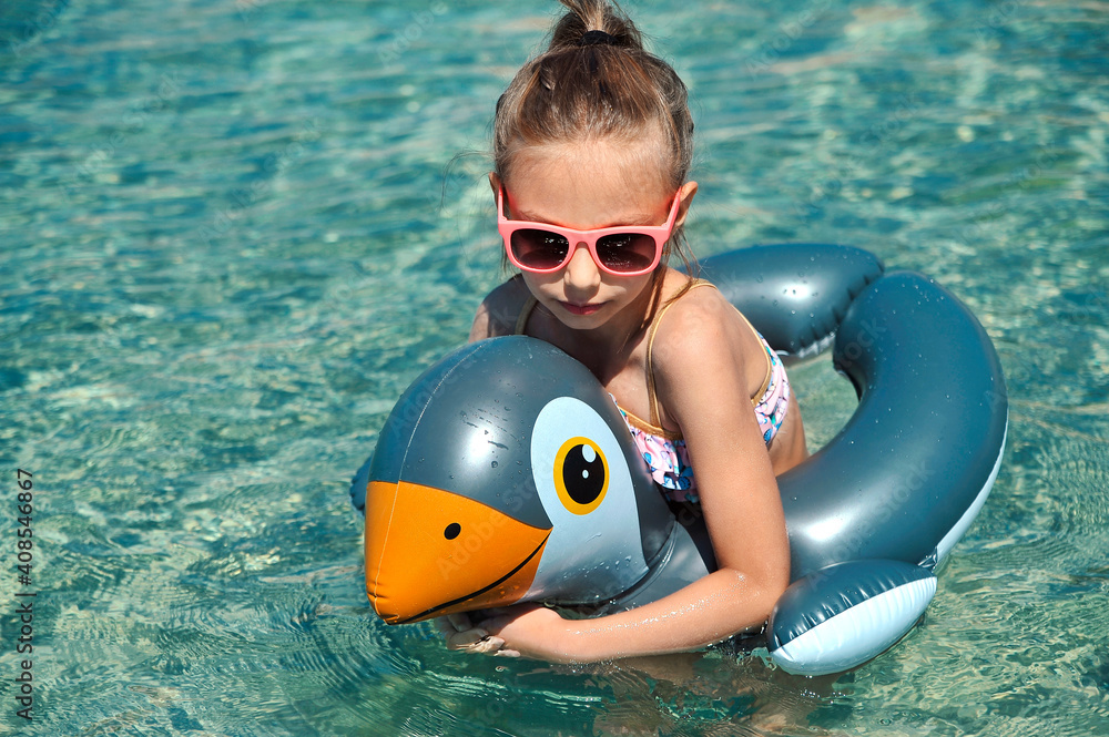 Summertime. Little girl swims in clear sea. Summer concept. Stock Photo ...